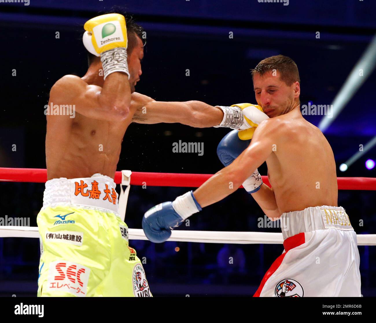 Japanese champion Daigo Higa, left, sends a left to French challenger Thomas Masson in the ...
