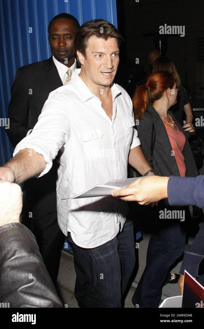 Actor Nathan Fillion signs autographs for fans as he attends a Halo ...