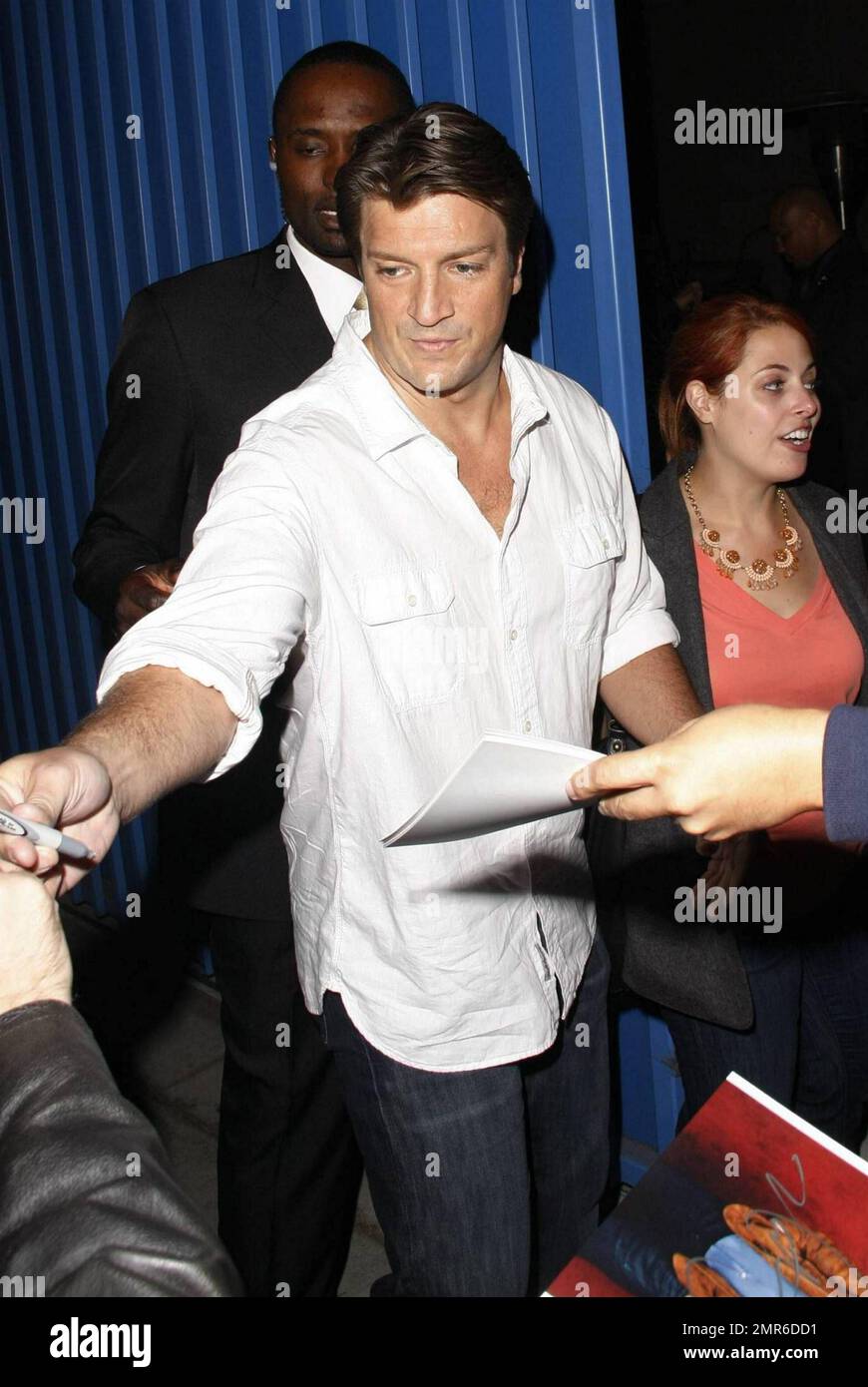 Actor Nathan Fillion signs autographs for fans as he attends a Halo ...