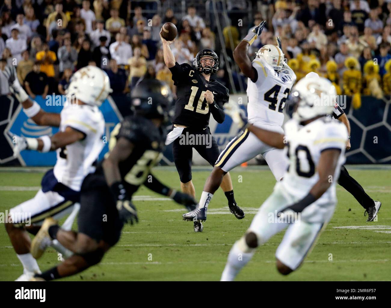 Wake Forest quarterback John Wolford, center, throws the ball in the ...