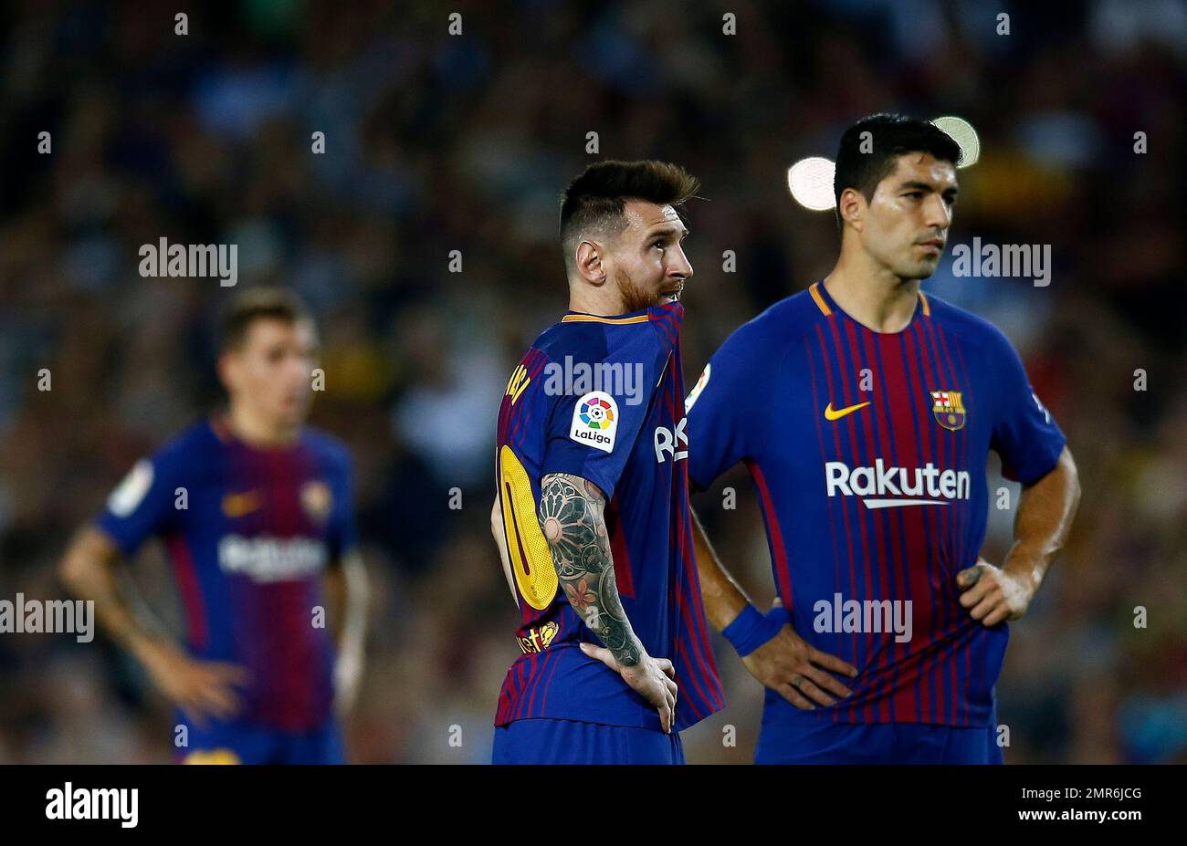 FC Barcelona's Lionel Messi, center, looks on next to Luis Suarez ...