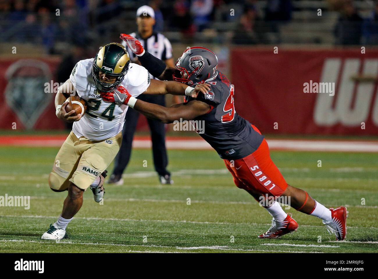 Colorado State running back Izzy Matthews (24) is slowed by New Mexico ...