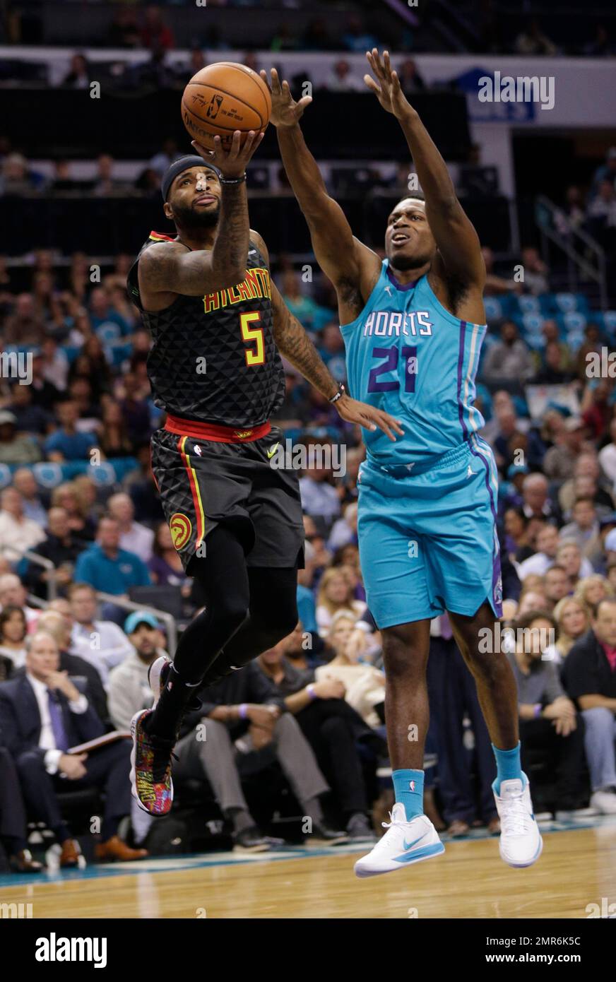 Atlanta Hawks' Malcolm Delaney (5) shoots past Charlotte Hornets ...