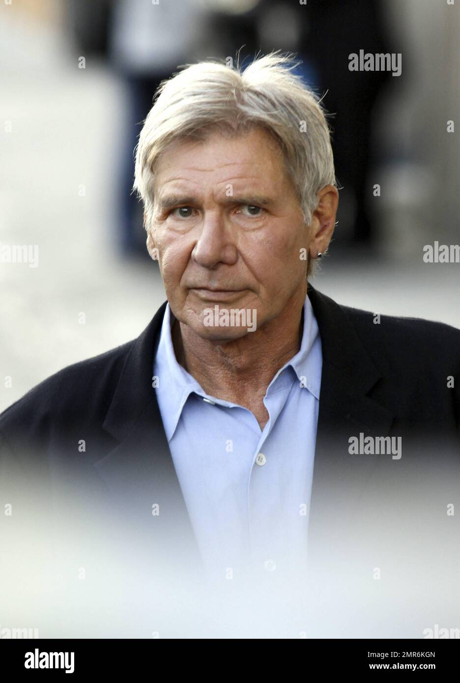 Harrison Ford is bombarded by a huge crowd of fans while signing ...
