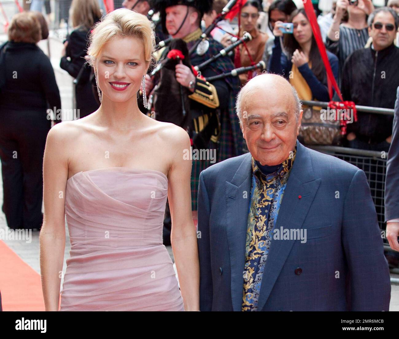 Czech model Eva Herzigova wears a figure hugging pink dress as she ...