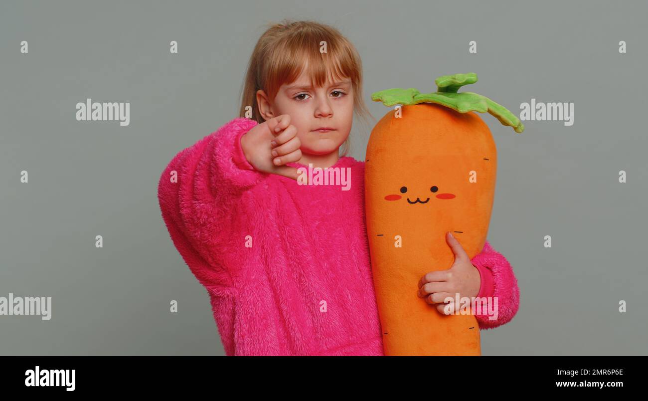 Dislike. Upset young preteen child girl kid showing thumbs down sign ...