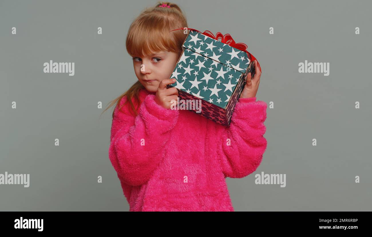 Happy toddler school girl receive, opening gift box and smiling ...