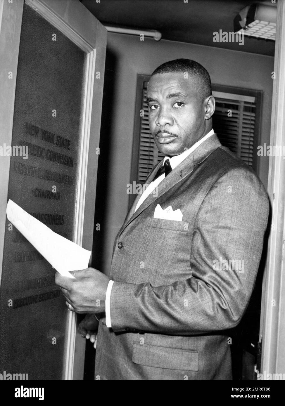Heavyweight boxer Sonny Liston carries his application for a license to ...