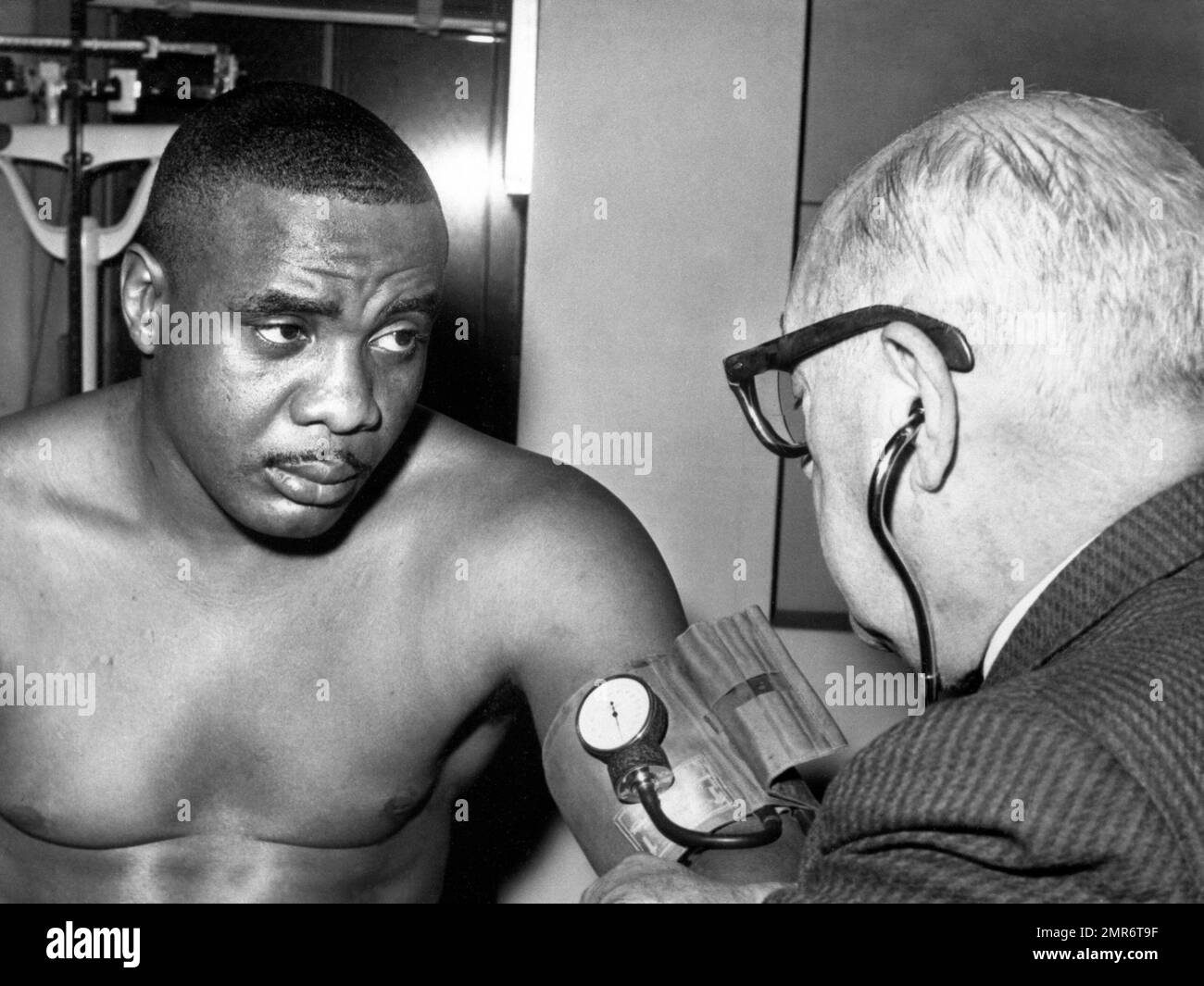Boxer Sonny Liston is examined by Dr Samuel Swetnick in New York City ...