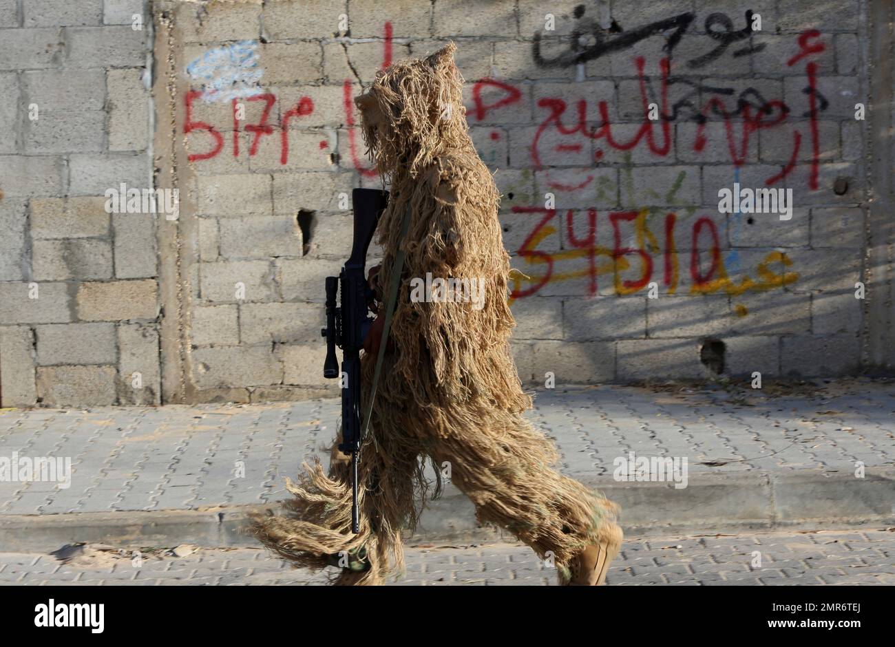 A masked militant of Great Prophet Brigades, the military wing of the ...
