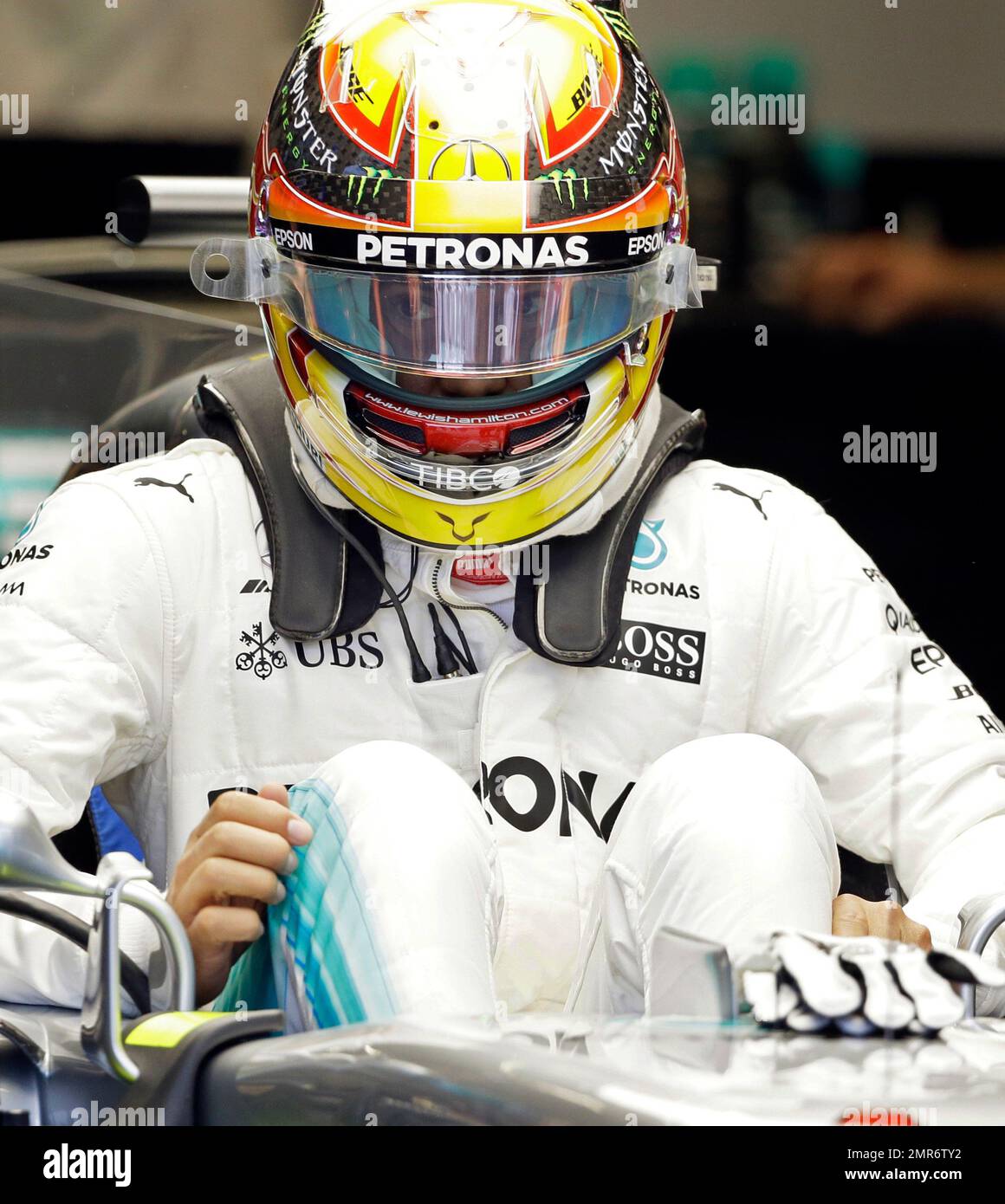 Mercedes driver Lewis Hamilton, of Britain, climbs into his car for the ...