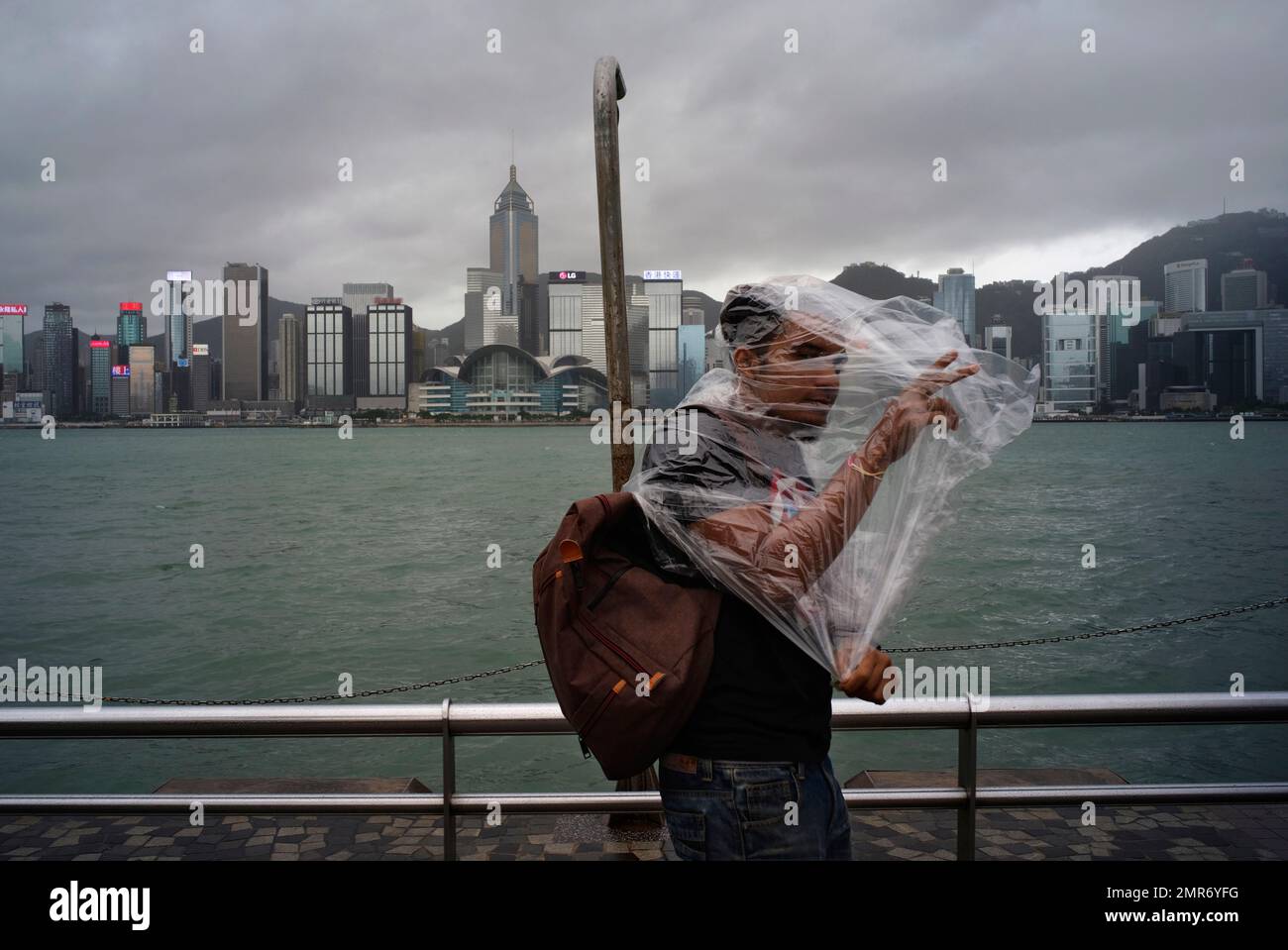 In this Sunday, Oct. 15, 2017, file photo, a man braves strong winds ...