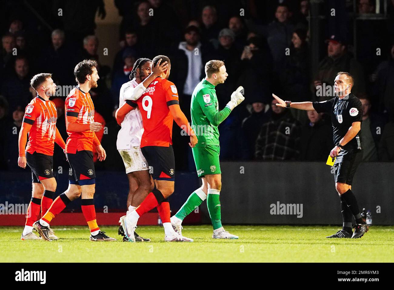 Luton Town's Carlton Morris is shown a yellow card by referee Geoff ...