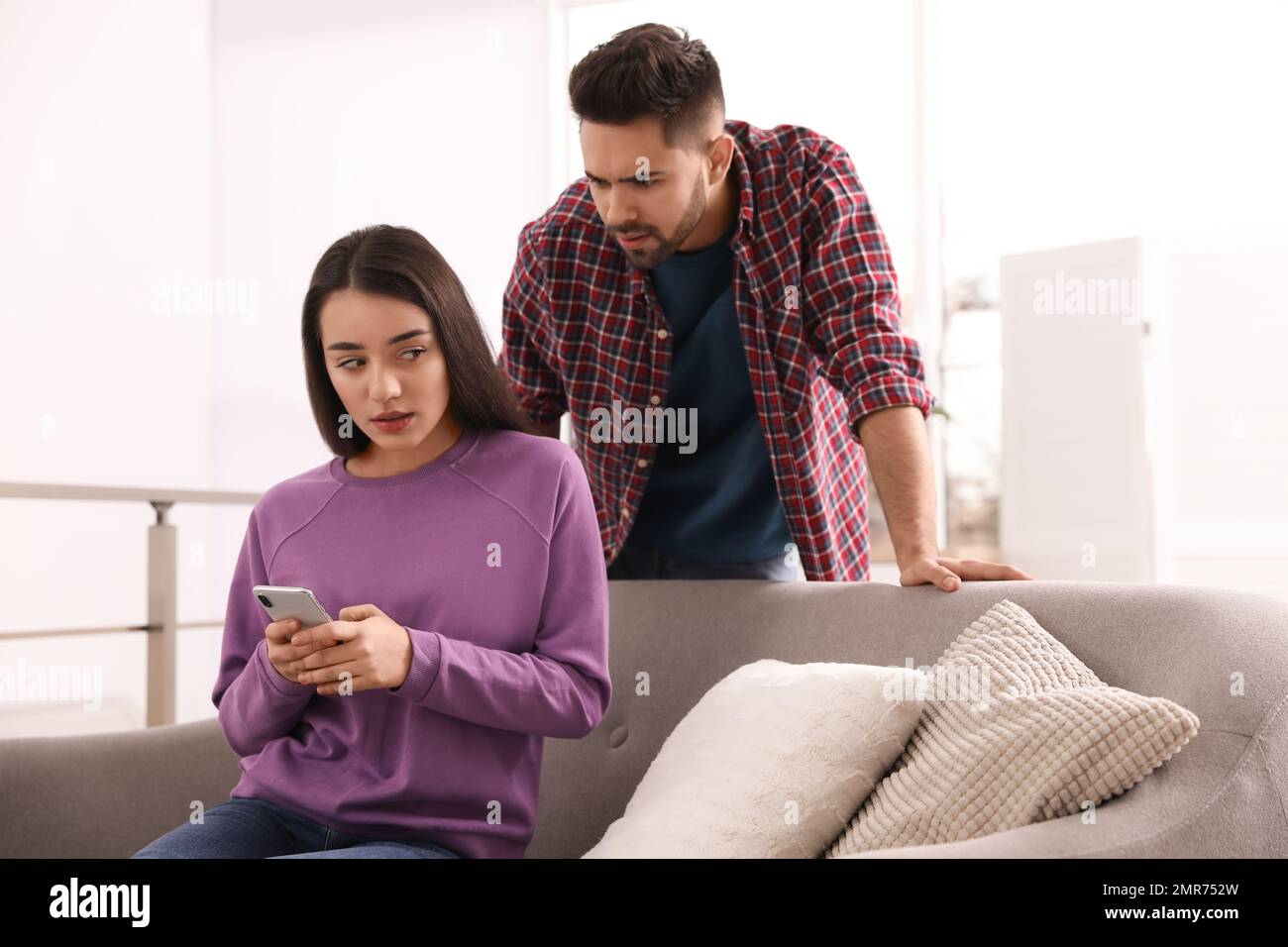 Woman looking distrustful at man hi-res stock photography and images ...