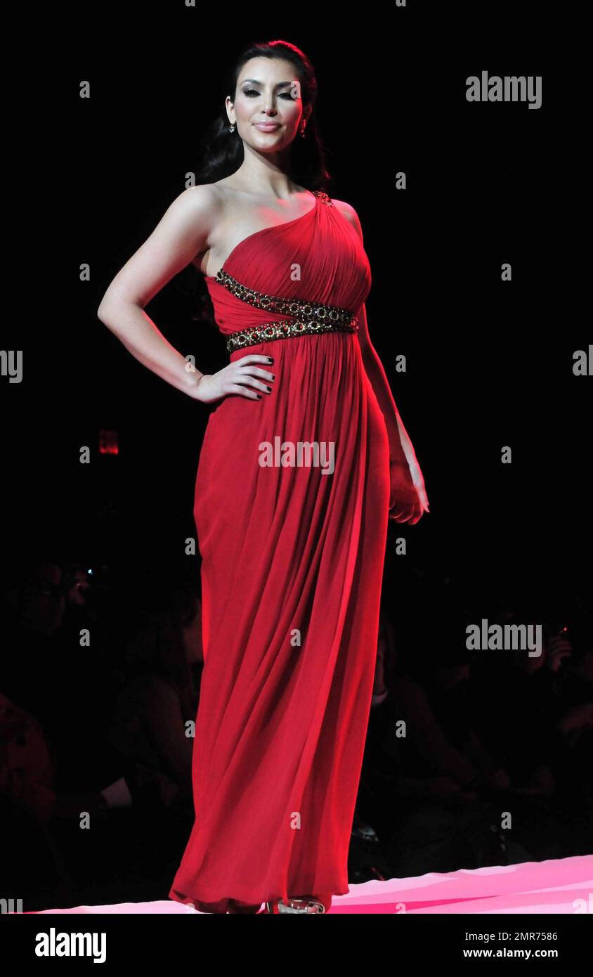 Kim Kardashian models a red dress at the annual Heart Truth Fashion ...
