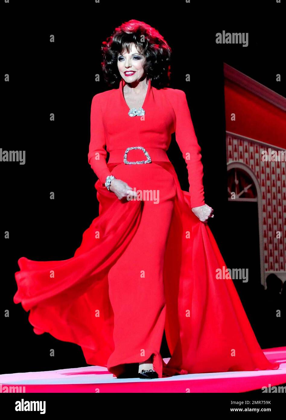 Joan Collins models a red dress at the annual Heart Truth Fashion Show ...