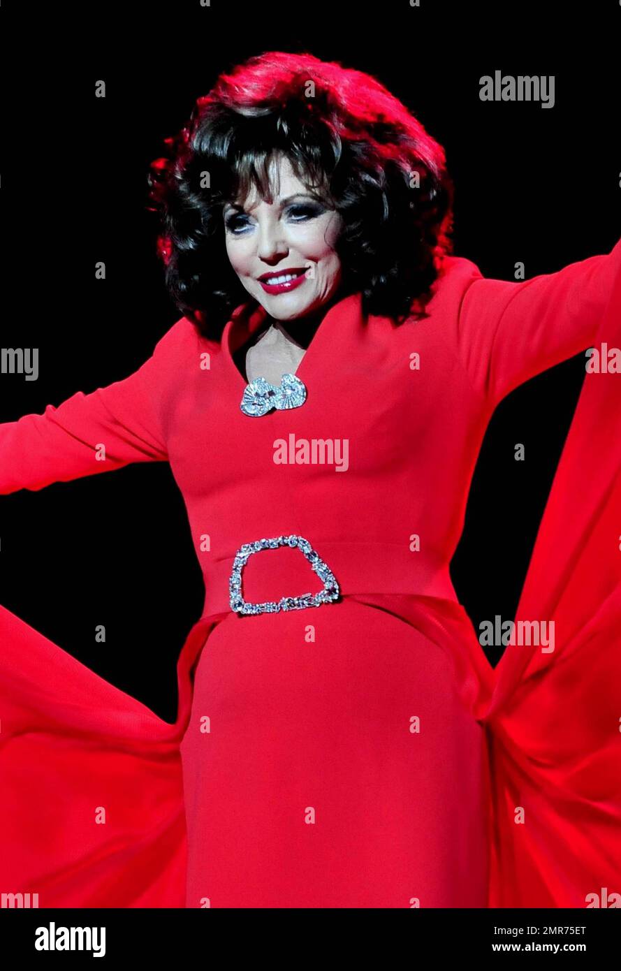 Joan Collins models a red dress at the annual Heart Truth Fashion Show ...