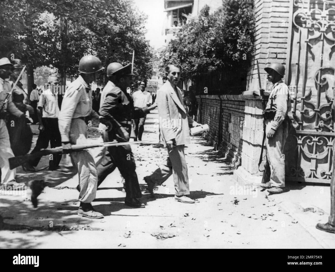 Police armed with rifles and fixed bayonets leading communist ...