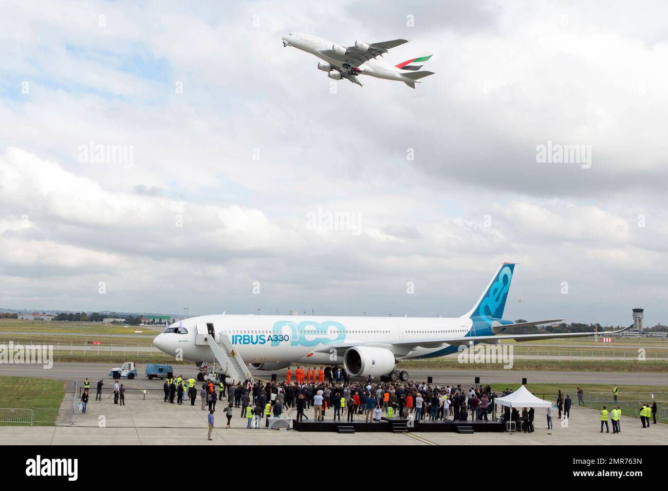 An Airbus A380 takes off while Airbus employees and members of the ...