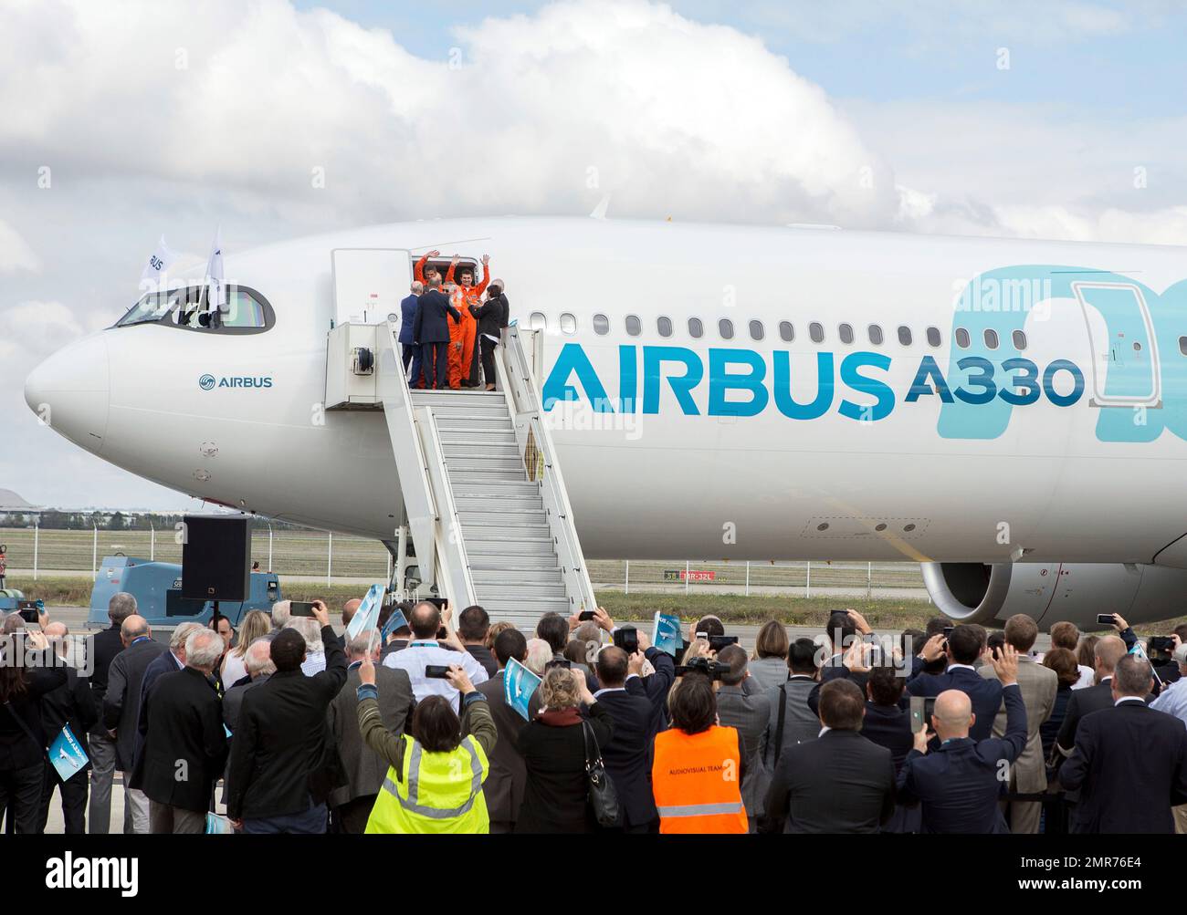 Airbus employees and members of the media gather near an Airbus A330neo ...