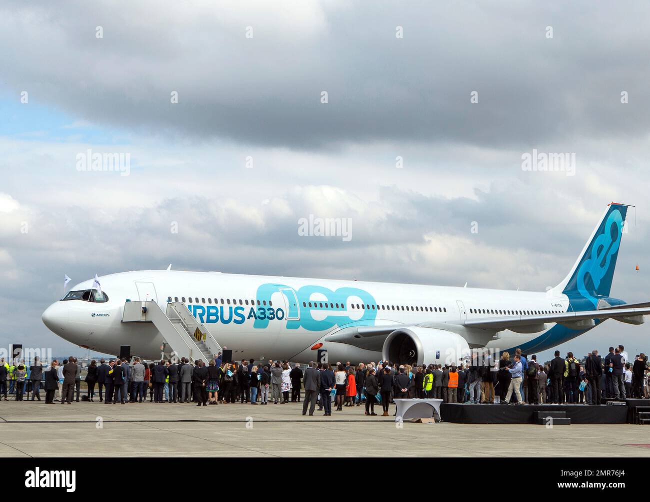 Airbus employees and members of the media gather near an Airbus A330neo ...