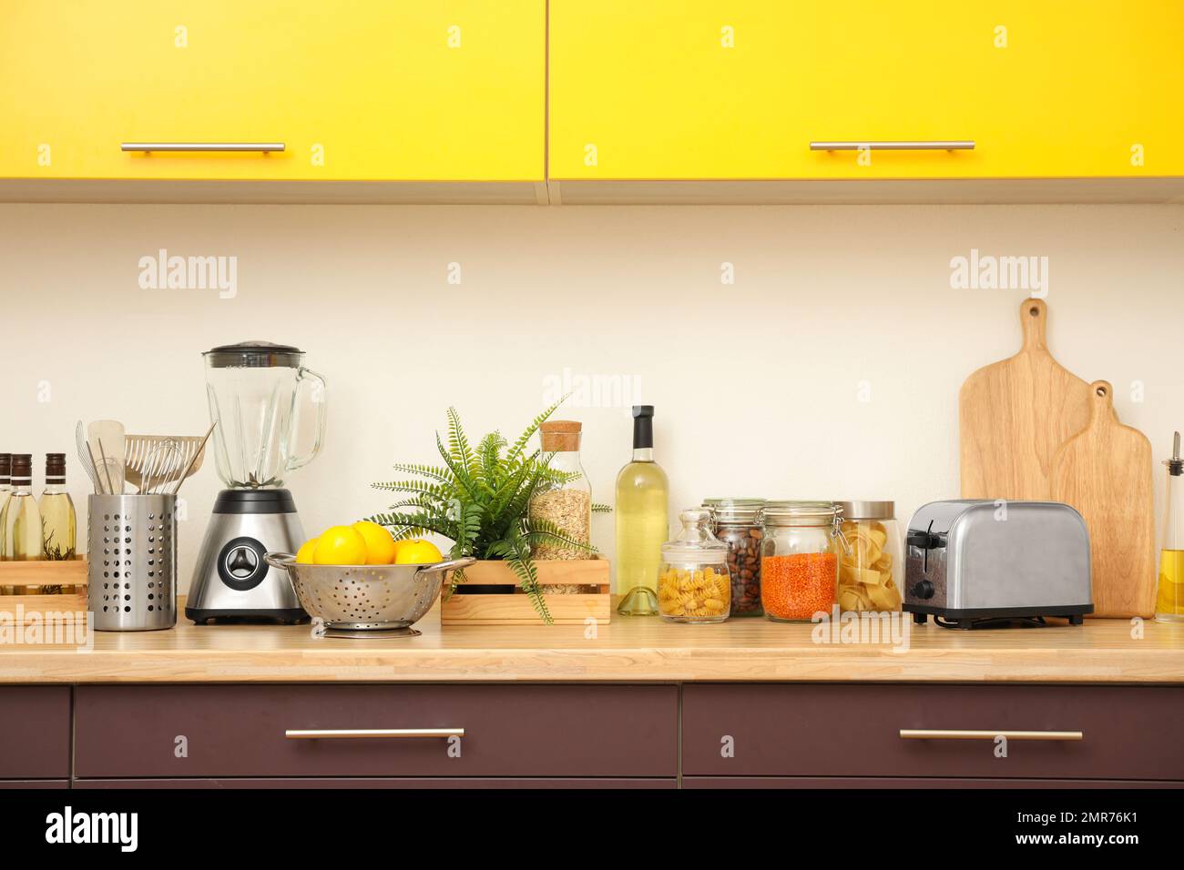 Stylish kitchen interior with wooden countertop and wall cabinets Stock ...
