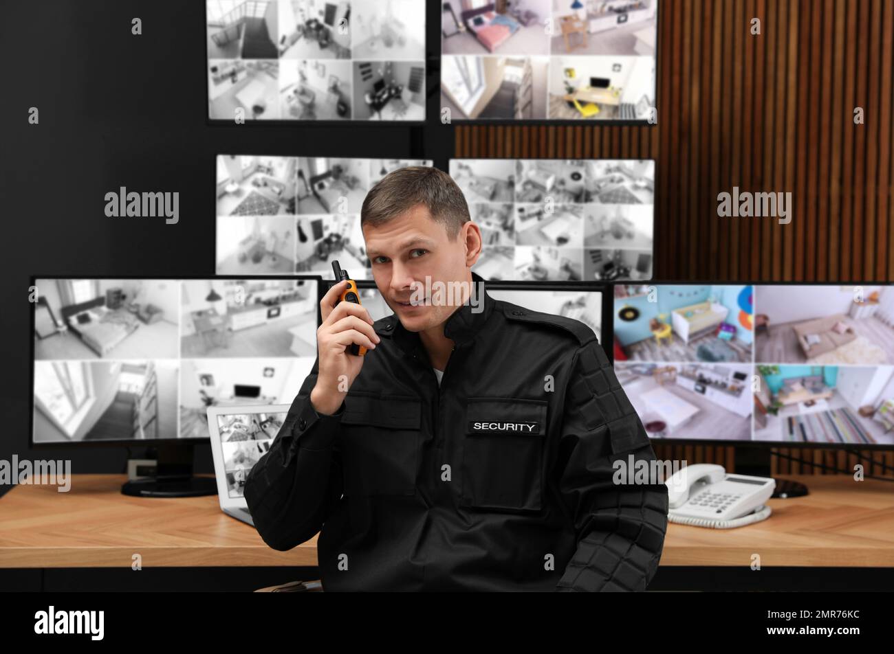 Security guard with portable transmitter at workplace in office Stock ...