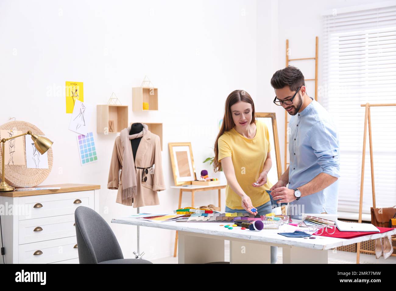 Fashion designers creating new clothes in studio Stock Photo - Alamy