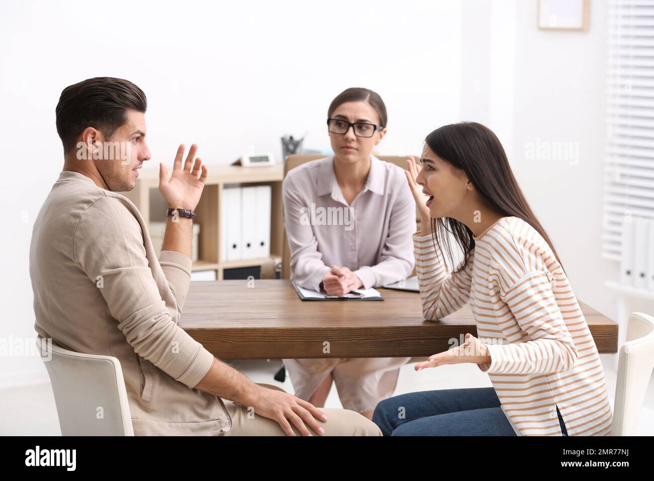 Professional psychologist working with couple in office Stock Photo - Alamy