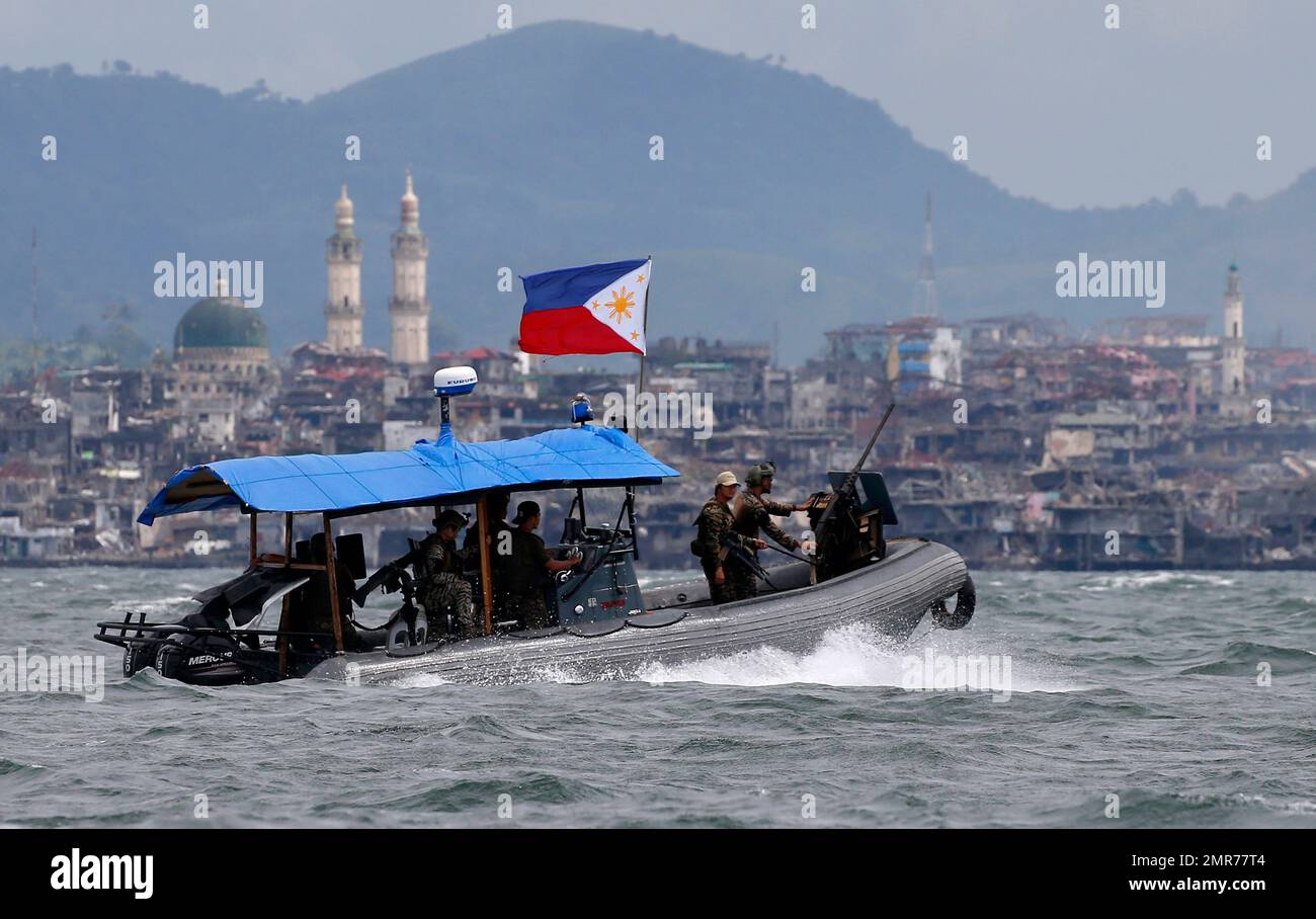 Philippine Navy commandos aboard a gunboat patrol the periphery of Lake ...