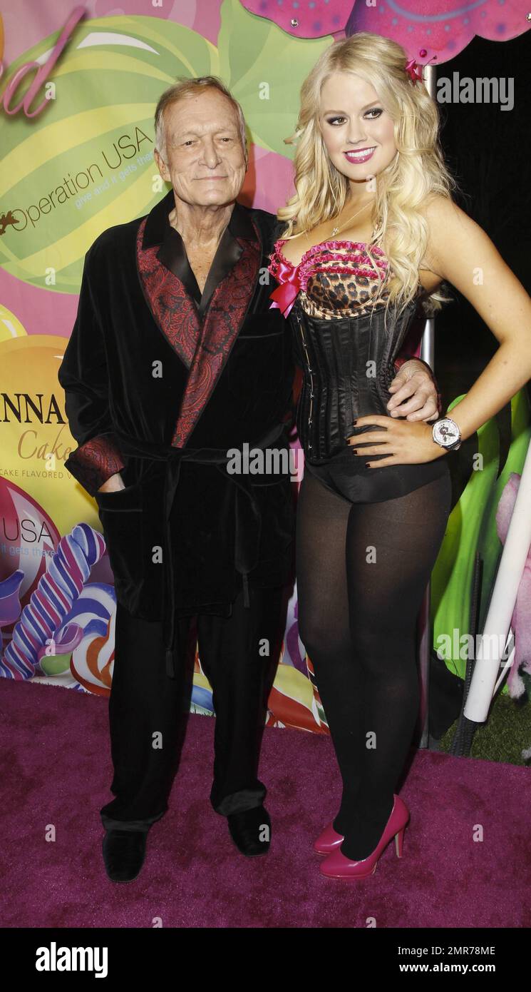 Despite his recent wedding cancellation, Hugh Hefner looked very happy as he posed with blonde ...