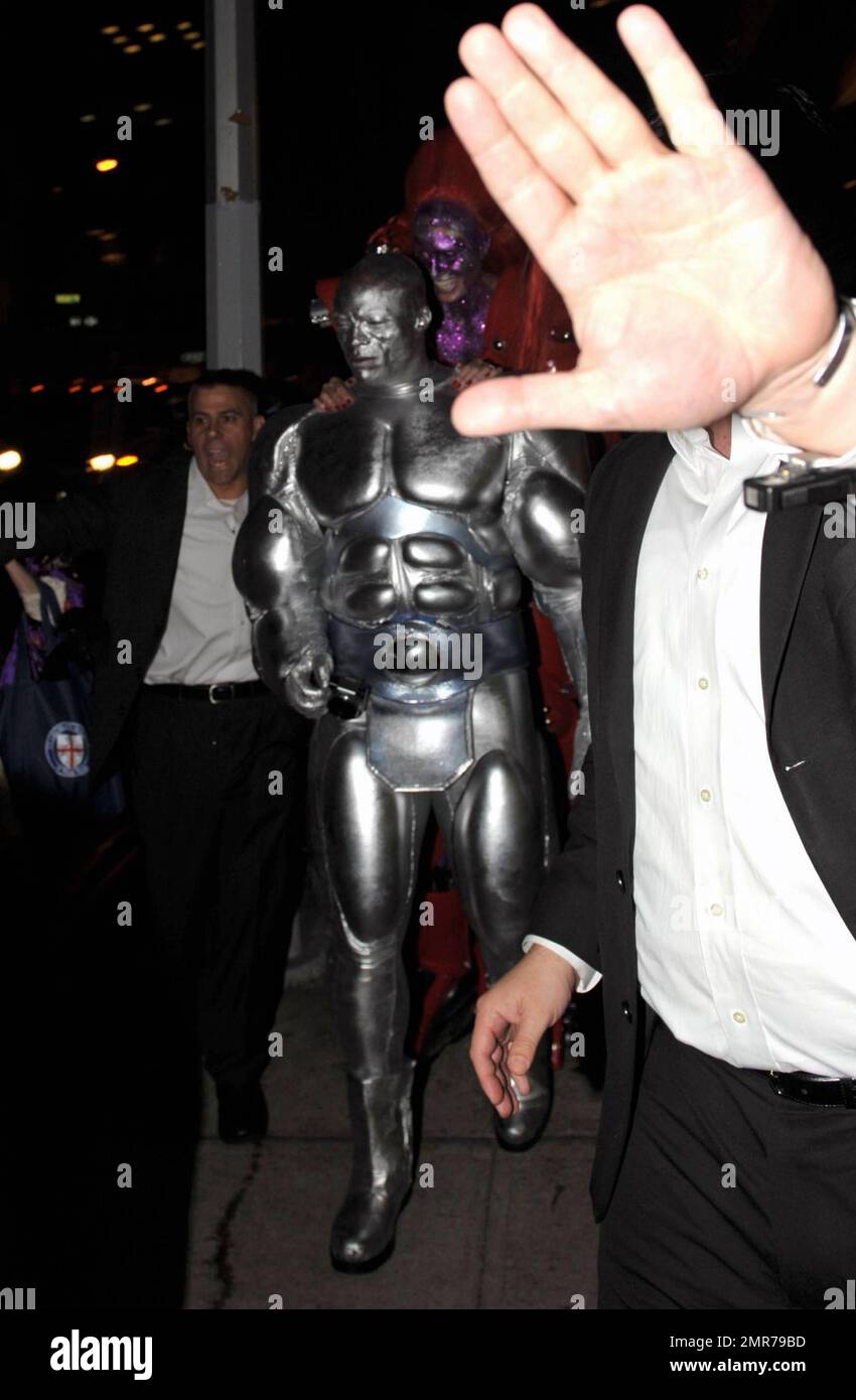 EXCLUSIVE!! Dressed as a silver futuristic superhero and a giant ...