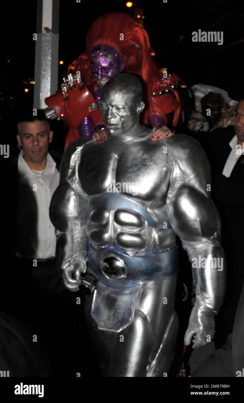 EXCLUSIVE!! Dressed as a silver futuristic superhero and a giant ...