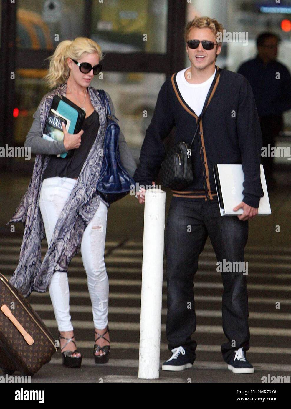 Heidi and Spencer Pratt arrive at LAX. Heidi is clutching a book called ...