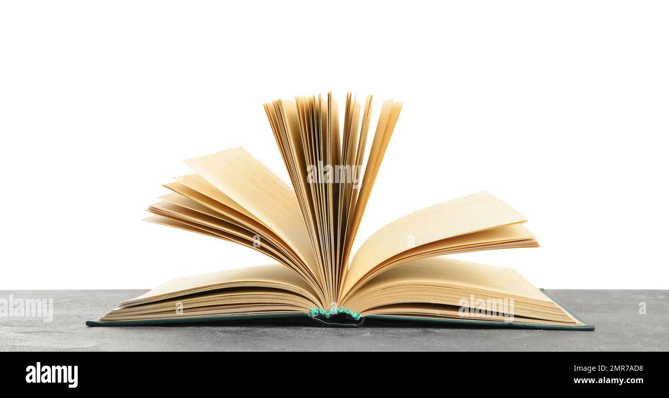 Open book on grey stone table against white background Stock Photo - Alamy