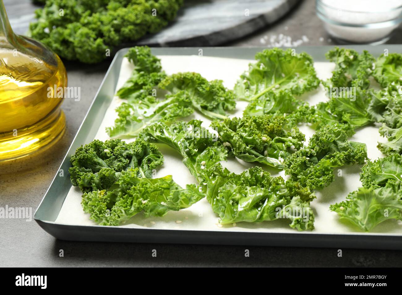 Raw cabbage leaves on grey table, closeup. Preparing kale chips Stock ...