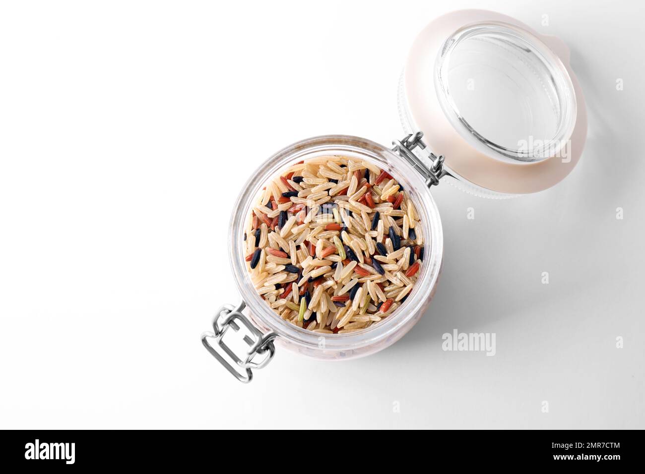 Mix of brown rice in jar isolated on white, top view Stock Photo - Alamy