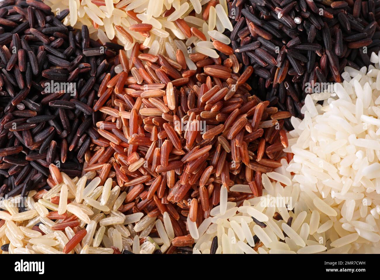 Different types of brown and polished rice as background, closeup Stock ...