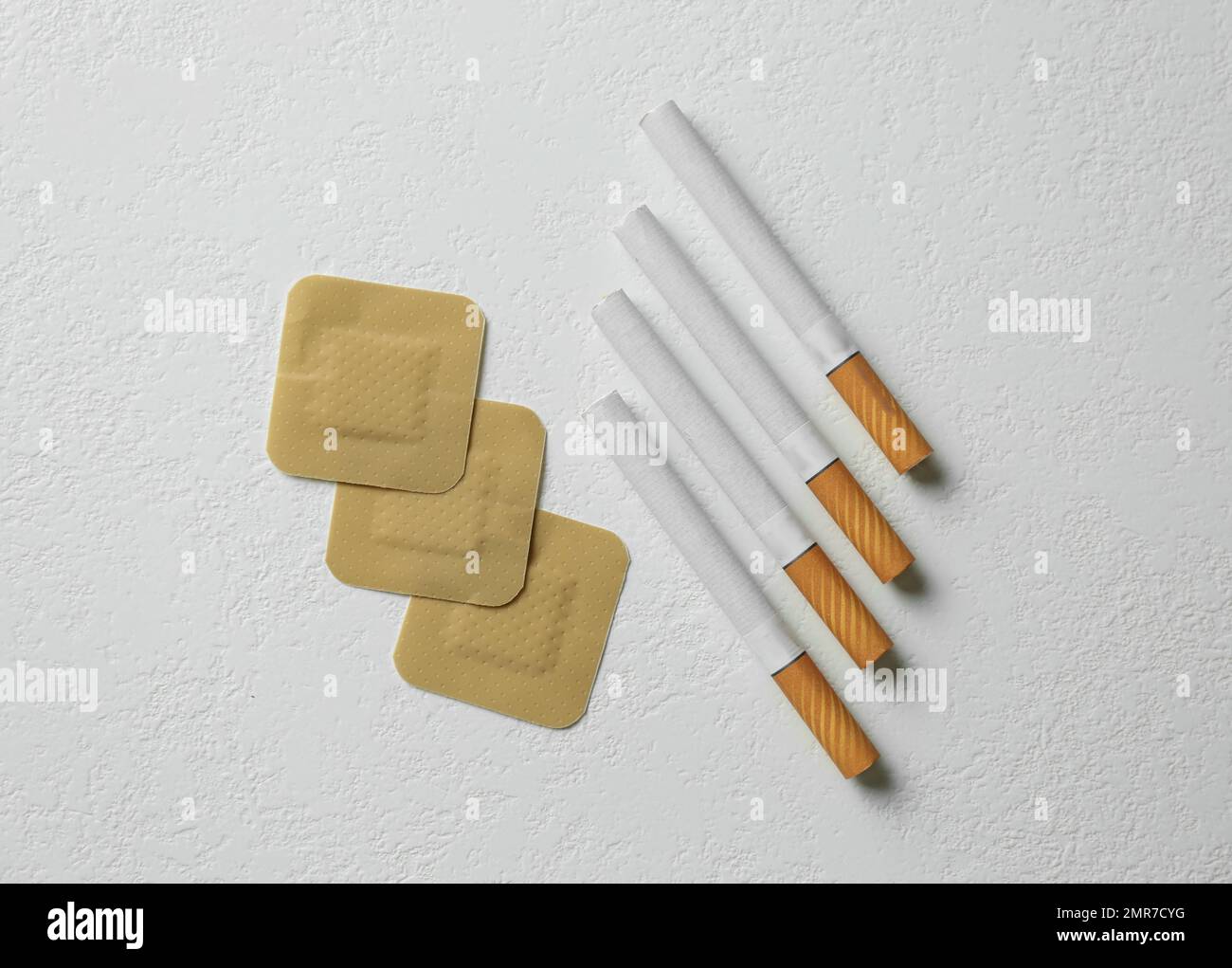 Nicotine patches and cigarettes on white background, flat lay Stock ...