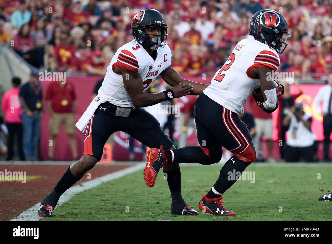 Utah running back Zack Moss, right, takes the handoff from quarterback ...