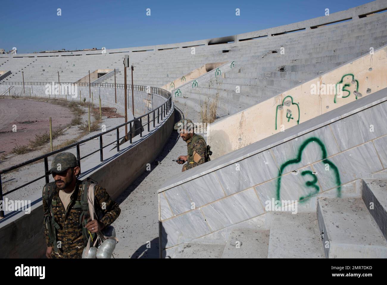 Members of the U.S.-backed Syrian Democratic Forces (SDF) clear the ...