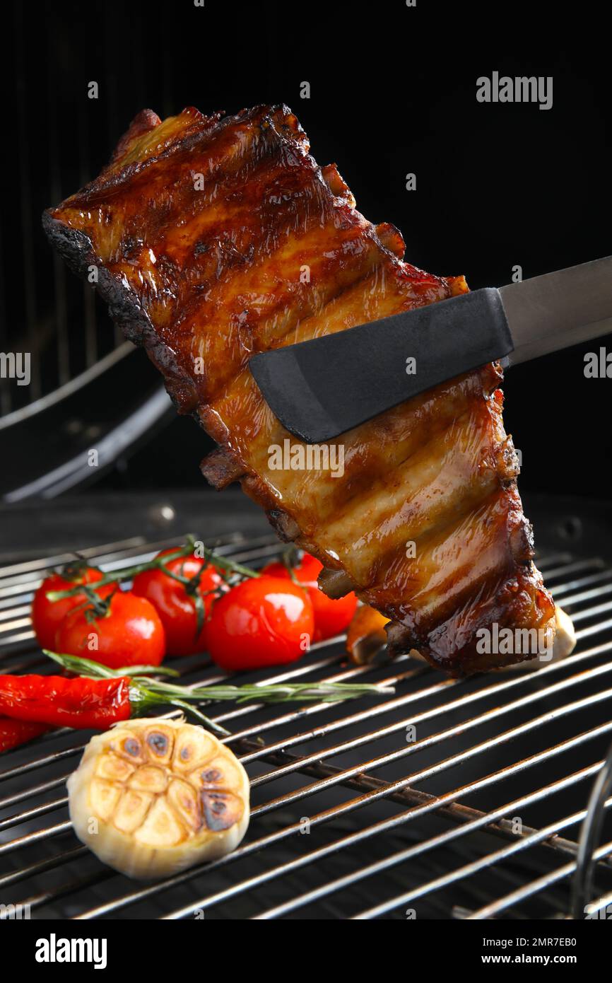 Delicious ribs and vegetables on barbecue grill Stock Photo - Alamy