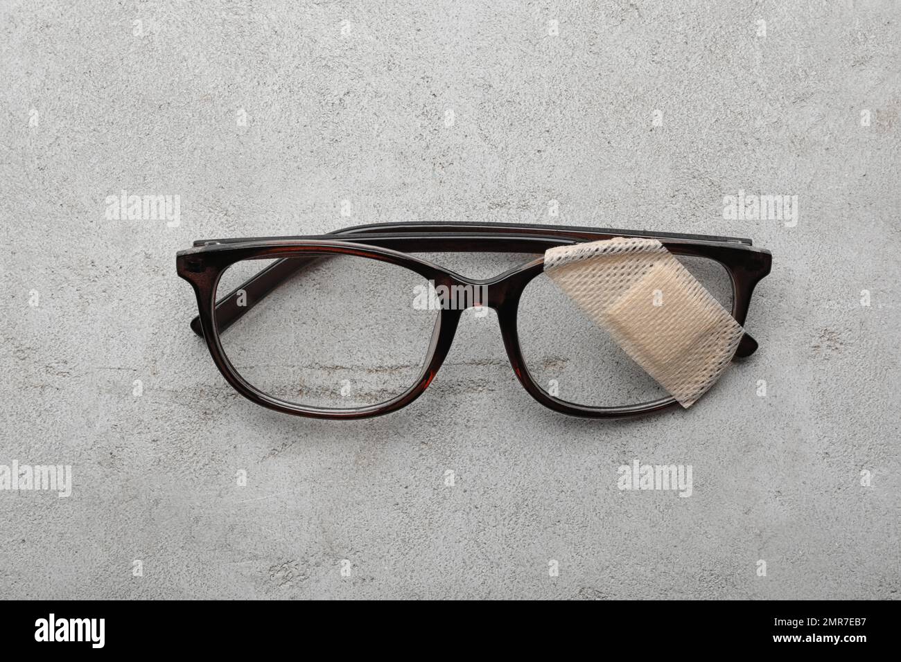 Glasses with sticking plaster on light grey stone table, top view Stock ...