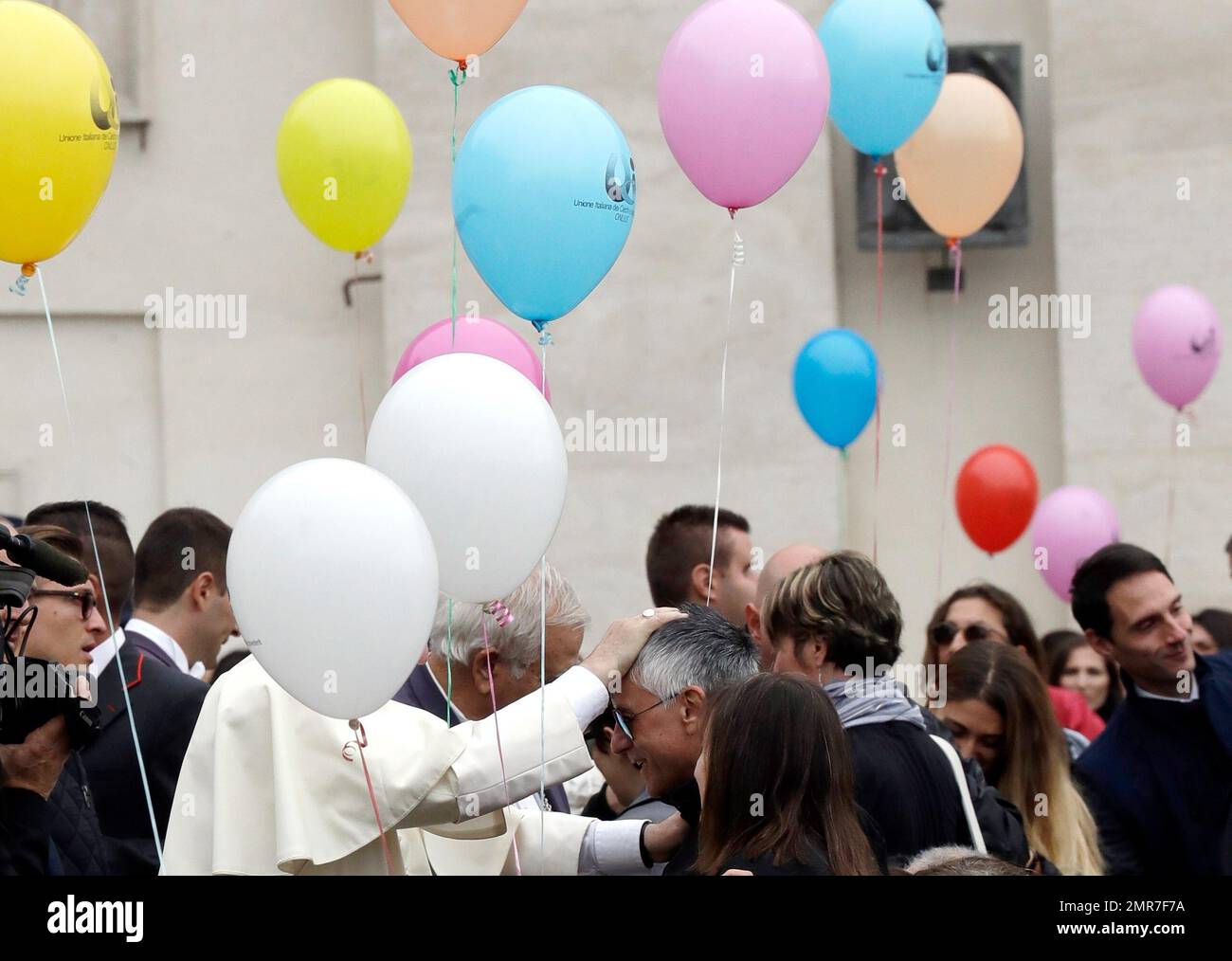 Pope Francis is surrounded by colored balloons as he blesses blind ...