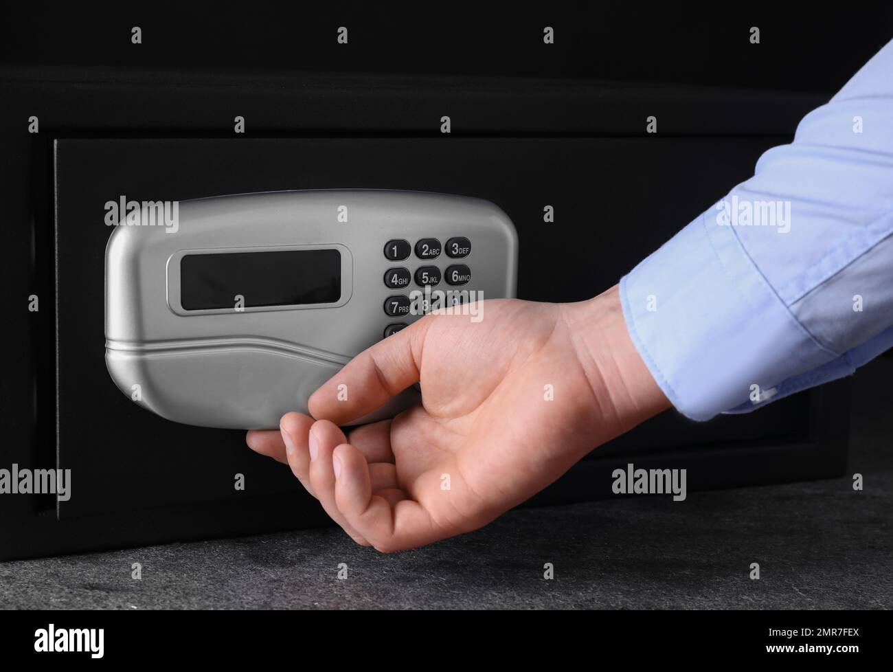 Man opening black steel safe with electronic lock, closeup Stock Photo ...