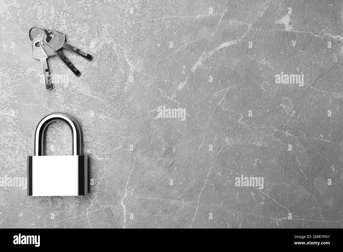 Steel padlock, keys and space for text on marble background, flat lay ...