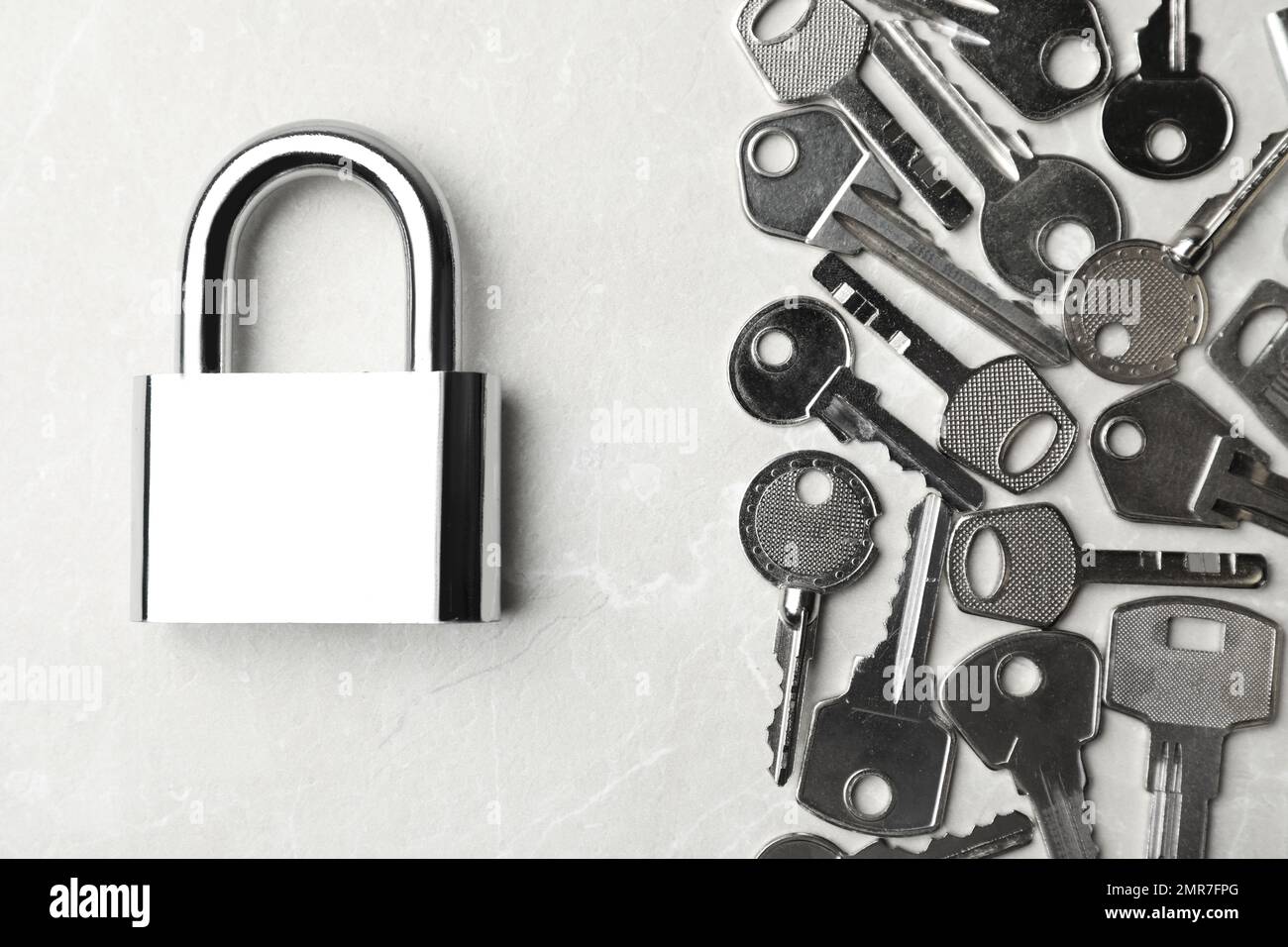 Steel padlock and keys on marble background, flat lay. Safety concept ...