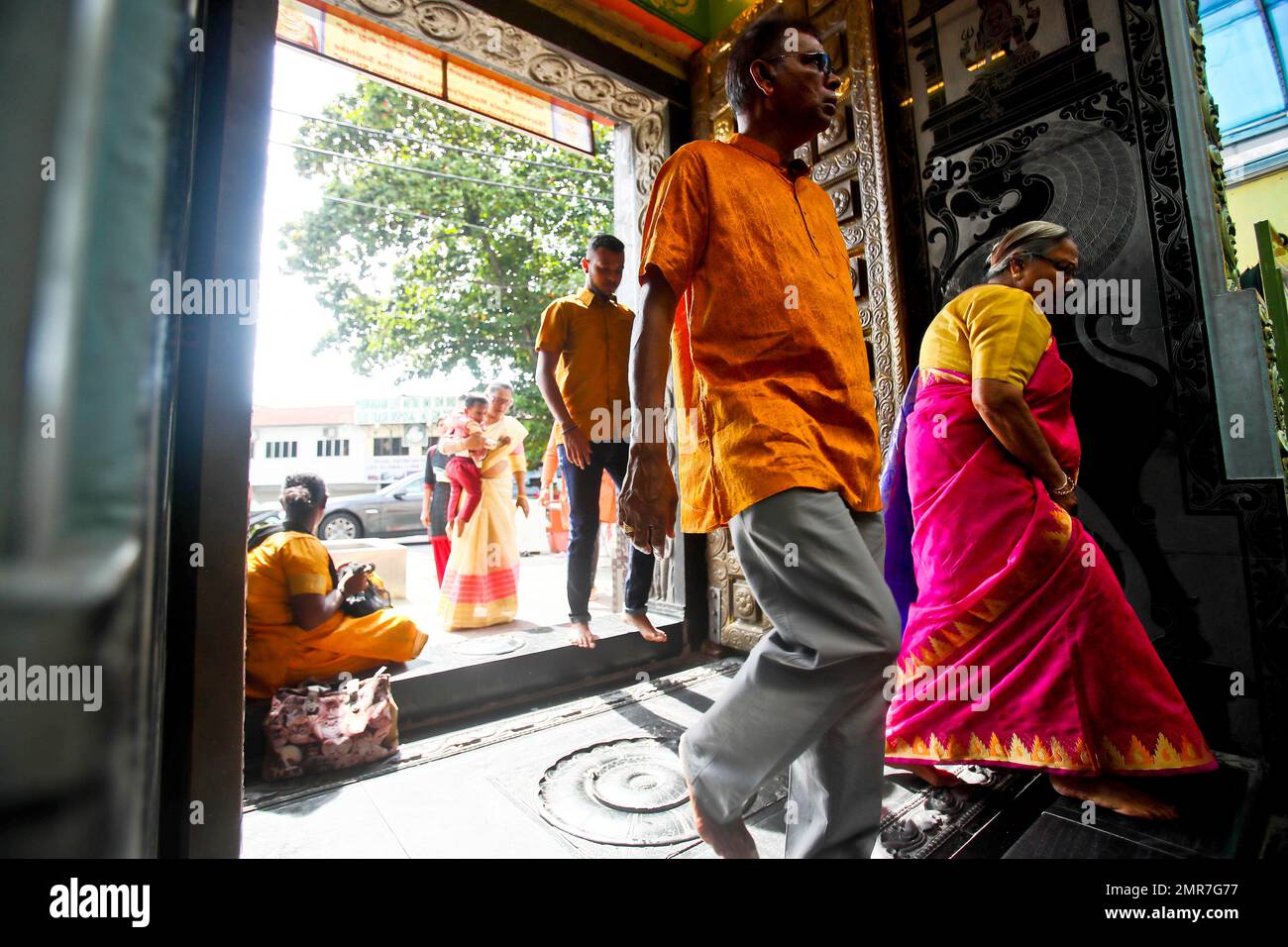 Hindu community enter a temple to pray during Deepavali celebration in ...