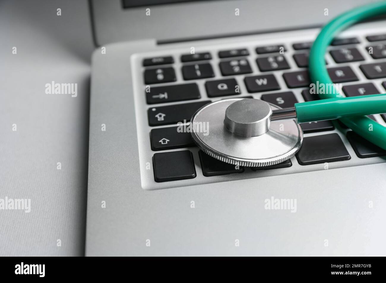 Laptop and stethoscope on light background, closeup. Concept of ...