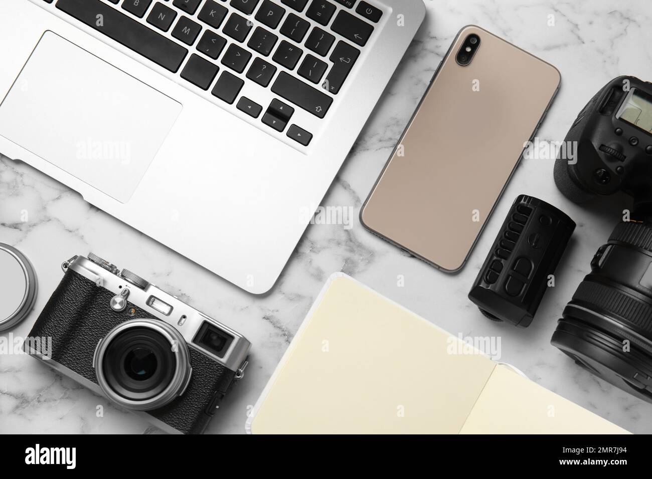Flat lay composition with laptop, cameras and smartphone on white ...
